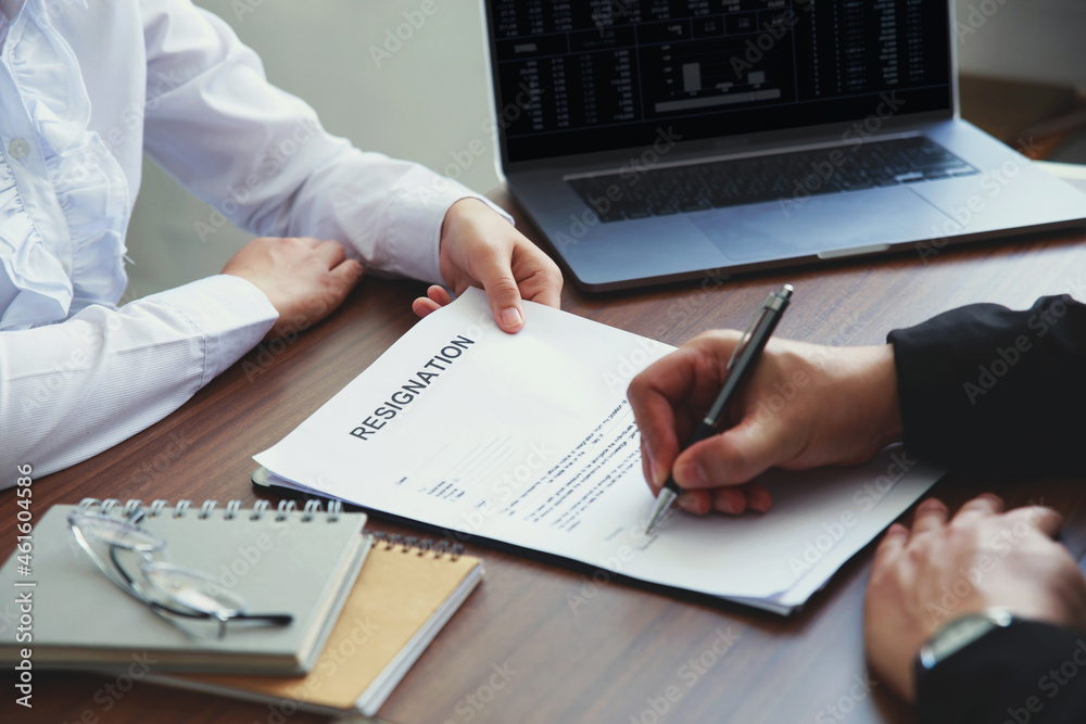 Resignation. A female employee submits the resignation document to the ...