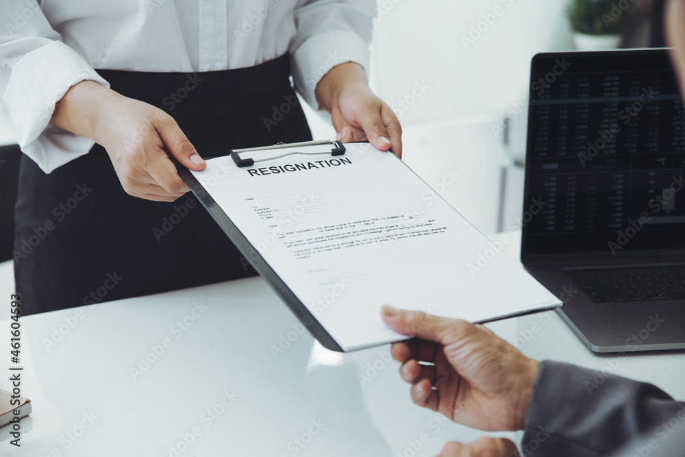 Resignation. A female employee submits the resignation document to the ...
