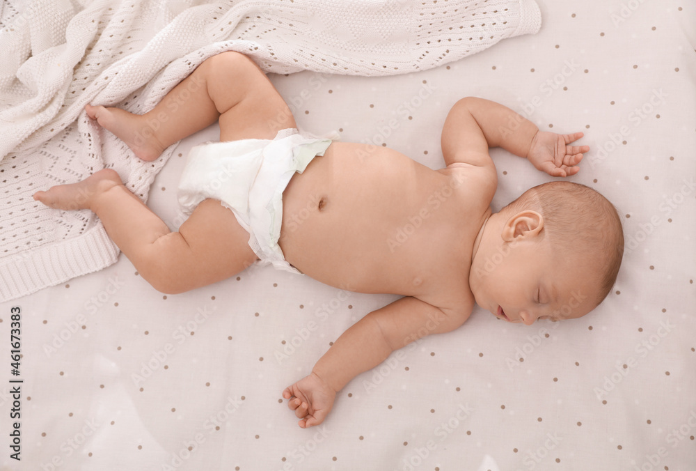 Cute little baby in diaper sleeping on bed, top view Stock Photo ...