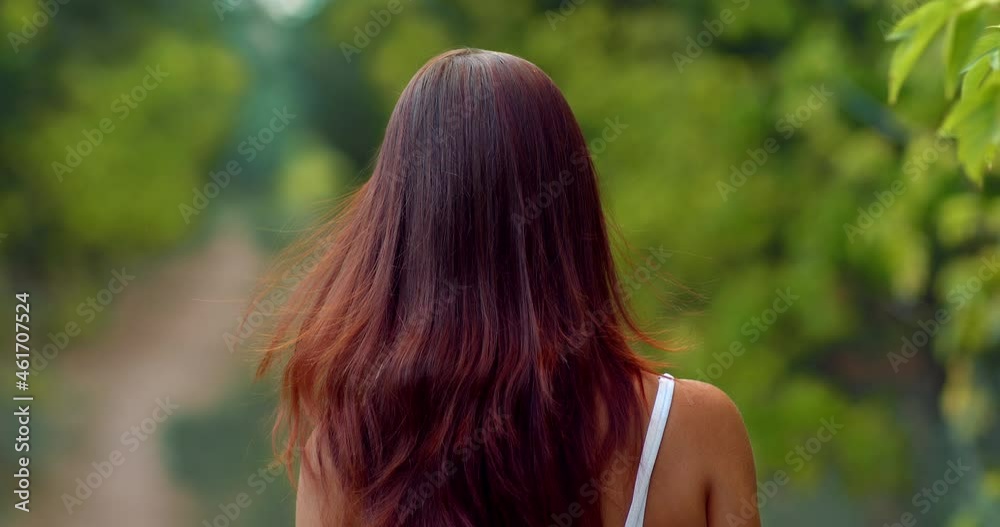 Portrait, a woman with long hair walking through the forest, a walk in ...