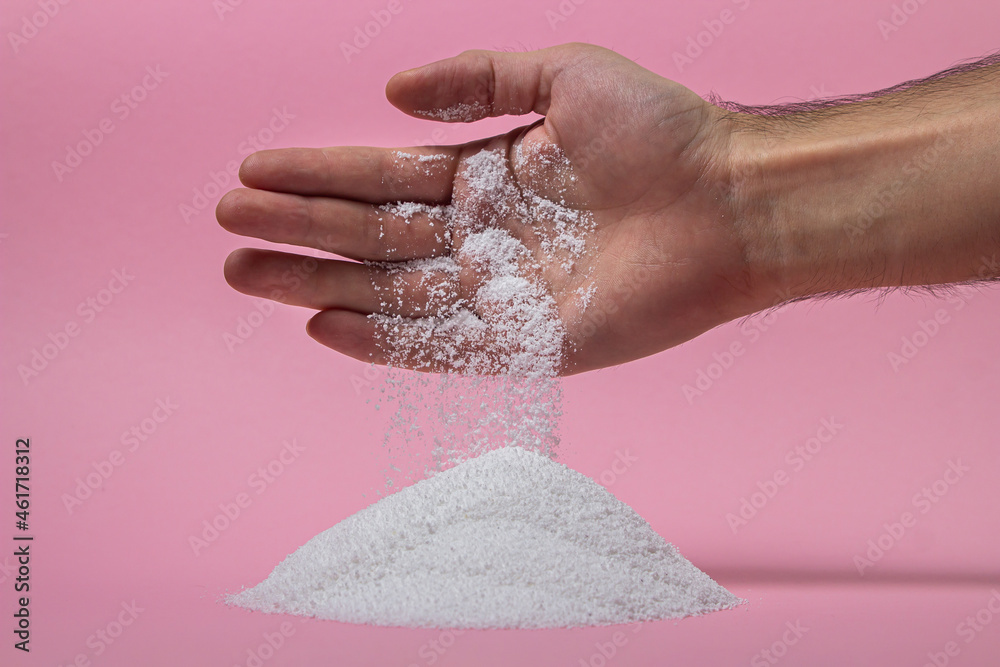 Washing powder on a pink background. Detergent for washing clothes ...