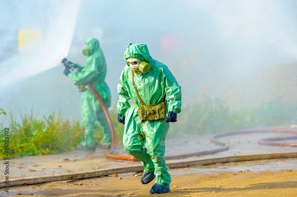 A rescuer in a chemical protection suit eliminates an ammonia leak and ...