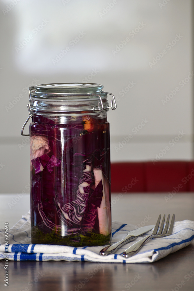 Pickled chunks of red cabbage in brine in a transparent glass jar ...
