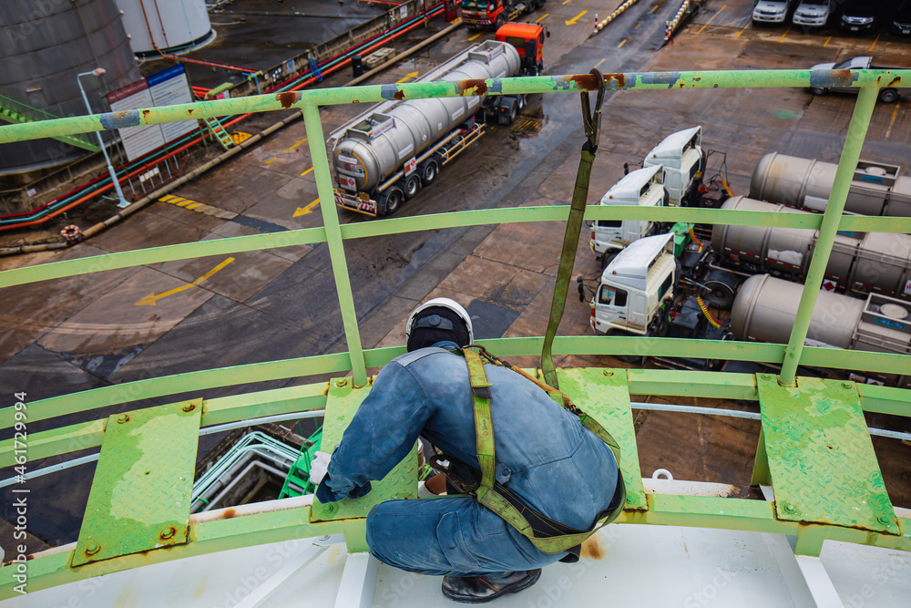 Male worker wearing safety first harness and safety lone working at ...