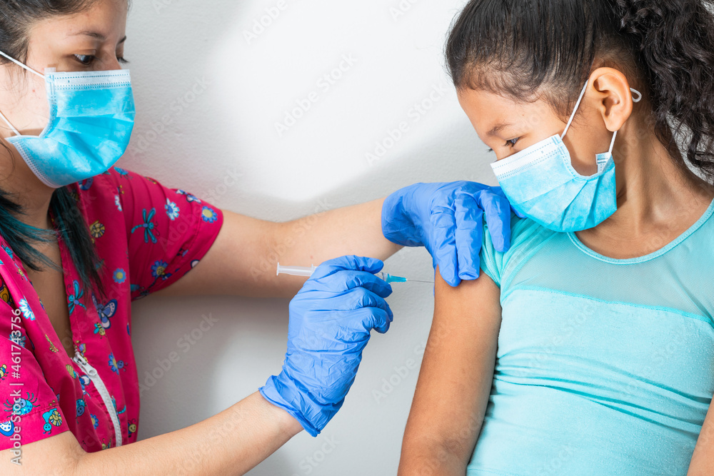 children's nurse injecting arm of little brown girl, girl afraid of ...