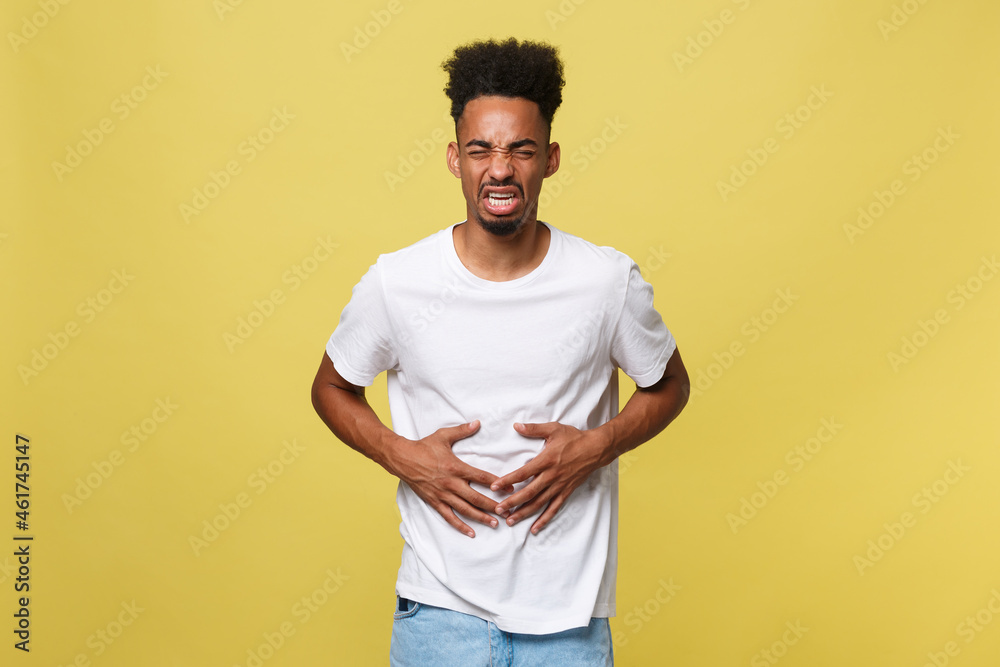 Closeup portrait of miserable, upset, young man, doubling over in ...