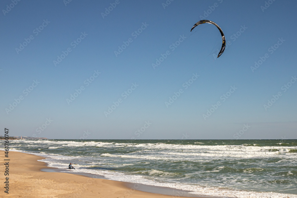 Water sport. Kite riding. Kitesurfing at sea. Board on the waves. Ride ...