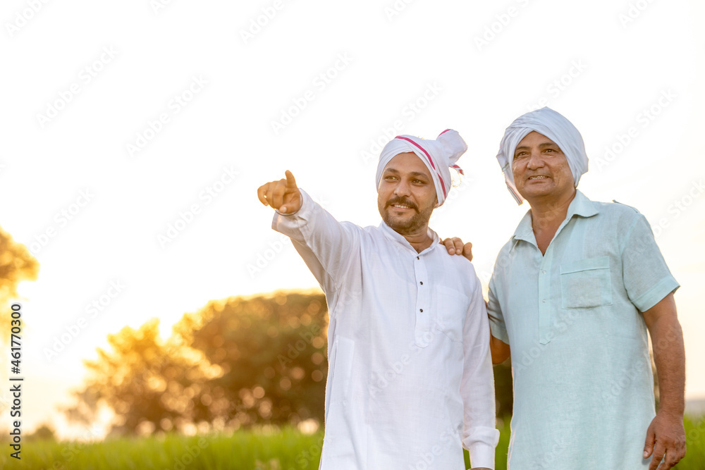 Portrait of happy young Indian rural man farmer sitting working in ...