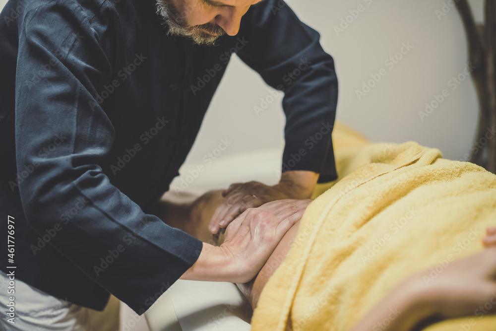 Soft focus view of man massaging a woman in a wellness center Oiled ...