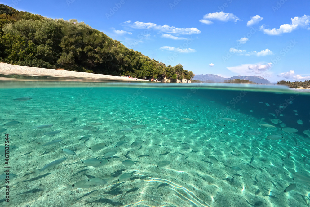 Underwater split photo of famous bay and sandy turquoise beach of ...