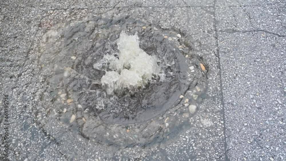 Water welling up from manhole. Floods. Streets in city after heavy ...