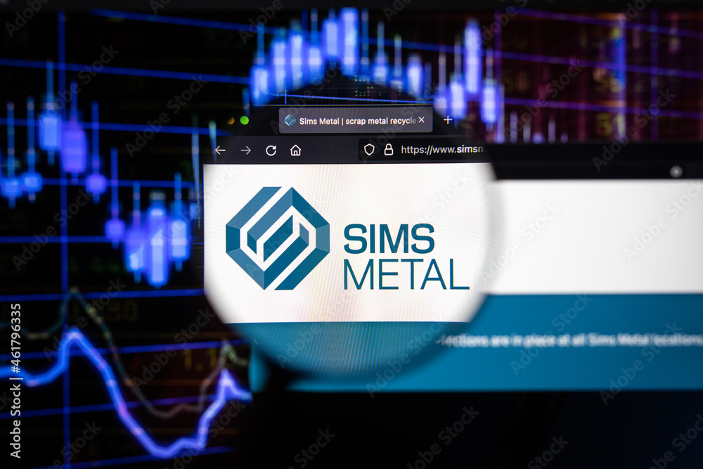Sims Metal company logo on a website with blurry stock market graphs in ...