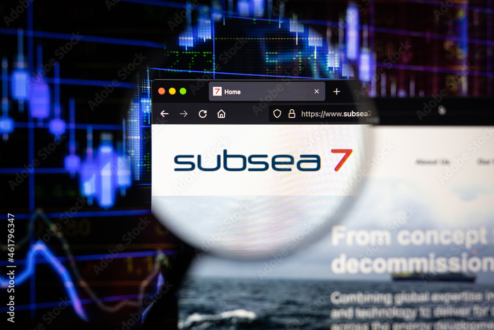 Subsea 7 company logo on a website with blurry stock market graphs in ...