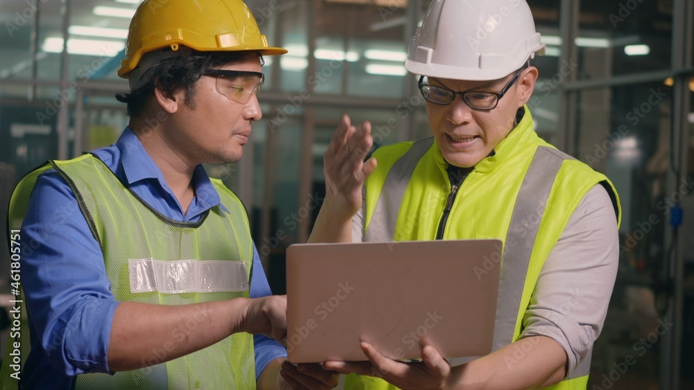 Two factory industrial workers technician or engineer and manager wear ...