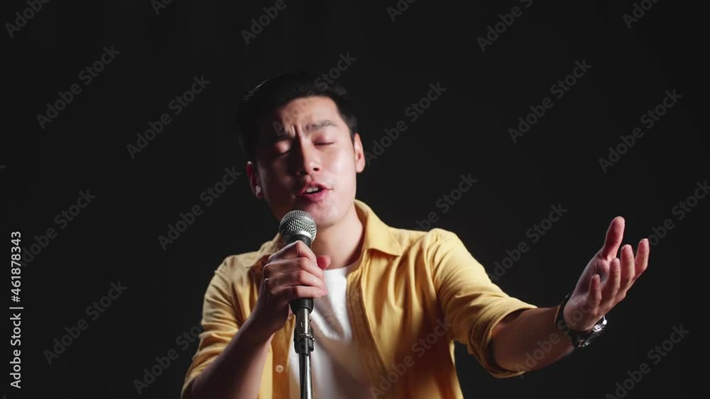 Asian Man Singer Singing Into Microphone On Black Background Stock ...