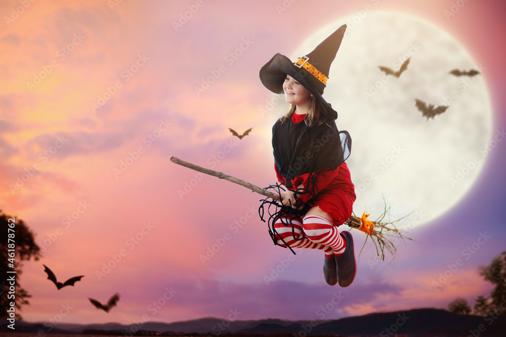 Halloween witch flying broom. Huge moon and bat. Stock Photo | Adobe Stock