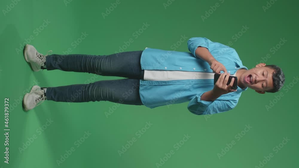 Full Body Of Inspired Asian Boy Flipping Through The Mobile Phone With ...