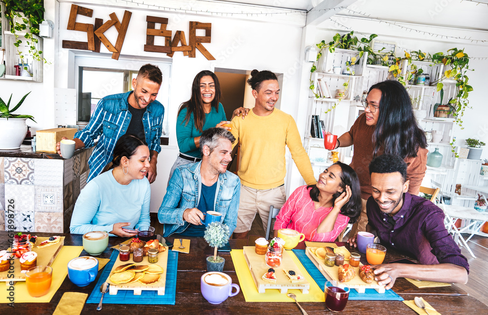 Friends having fun at breakfast buffet - Trendy multicultural people ...