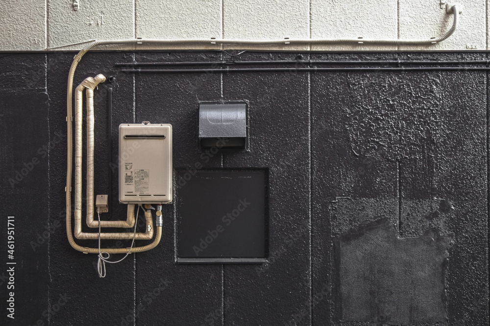 Black and white wall with water heater connected background texture ...