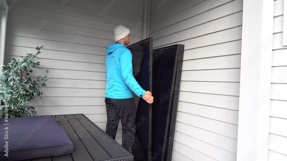 Vidéo Stock Person carrying solar panel and stacking several panels up ...
