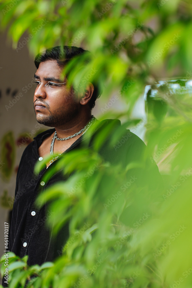 portrait of dark skinned Indian man surrounded by leaves Stock Photo ...