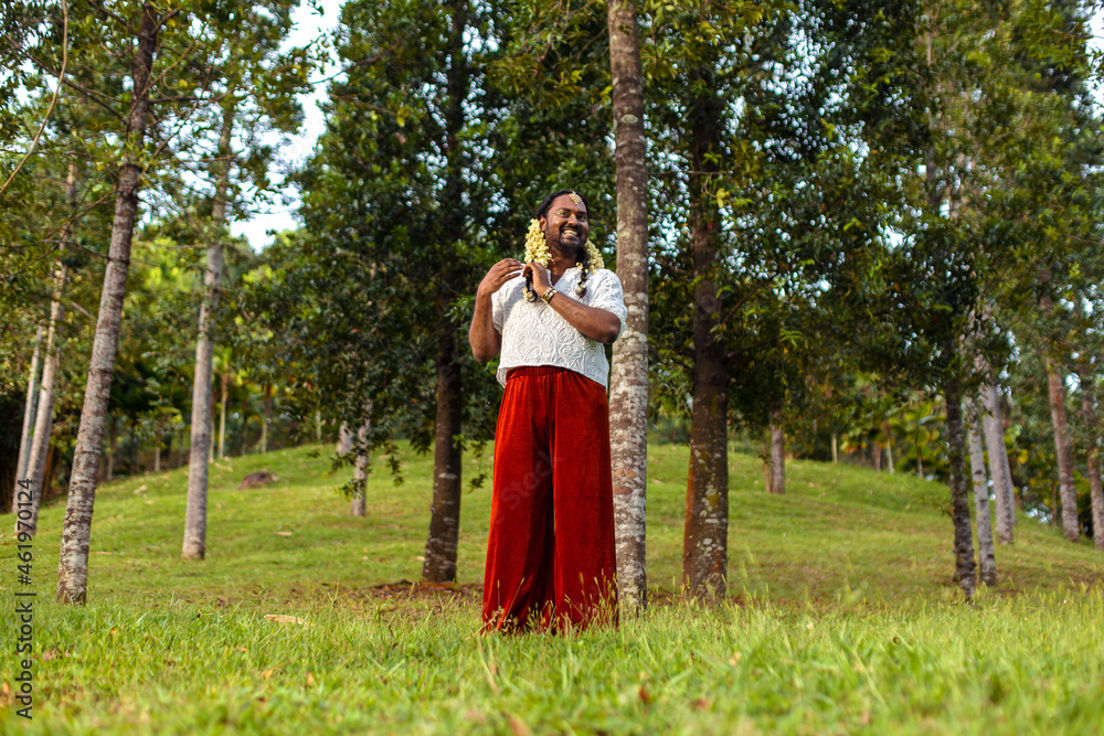 portrait of dark skinned Indian non-binary individual with traditional ...