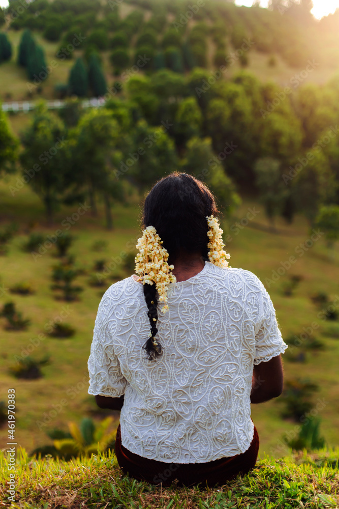 portrait of dark skinned Indian non-binary individual with traditional ...