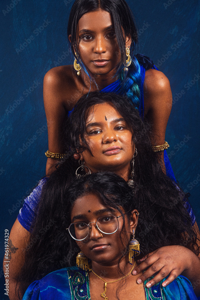 group portraits of dark skinned Indian women from Malaysia against a ...