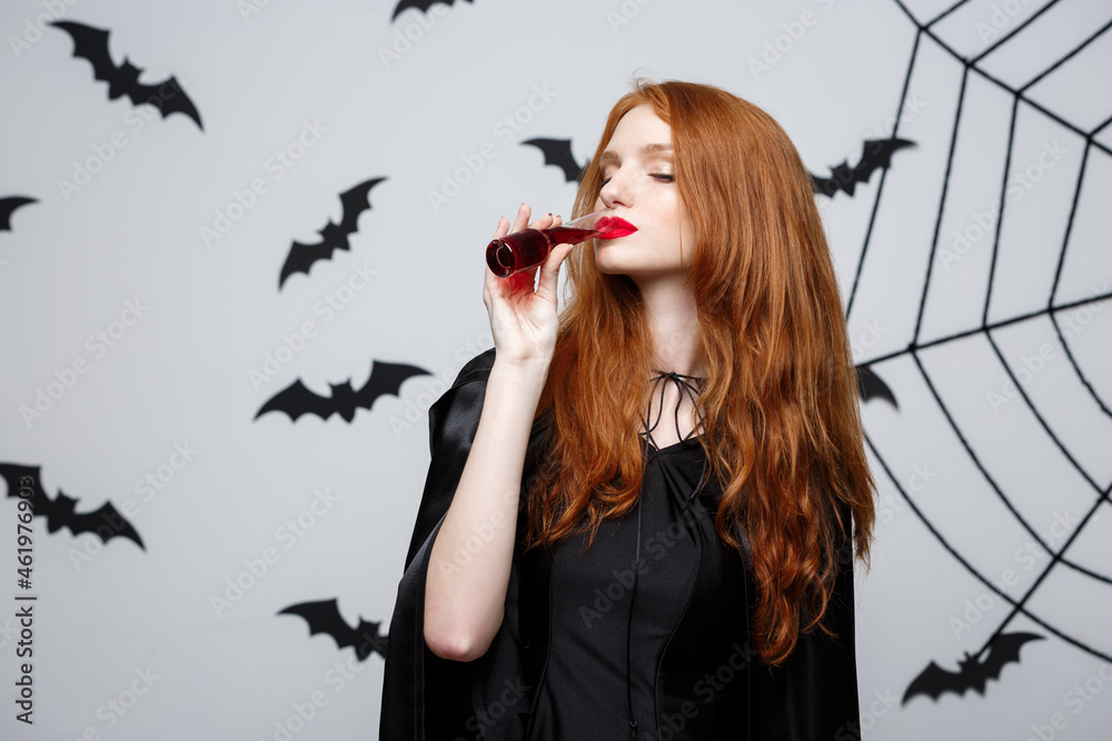 Halloween witch concept - Happy Halloween Witch drinking blood over ...