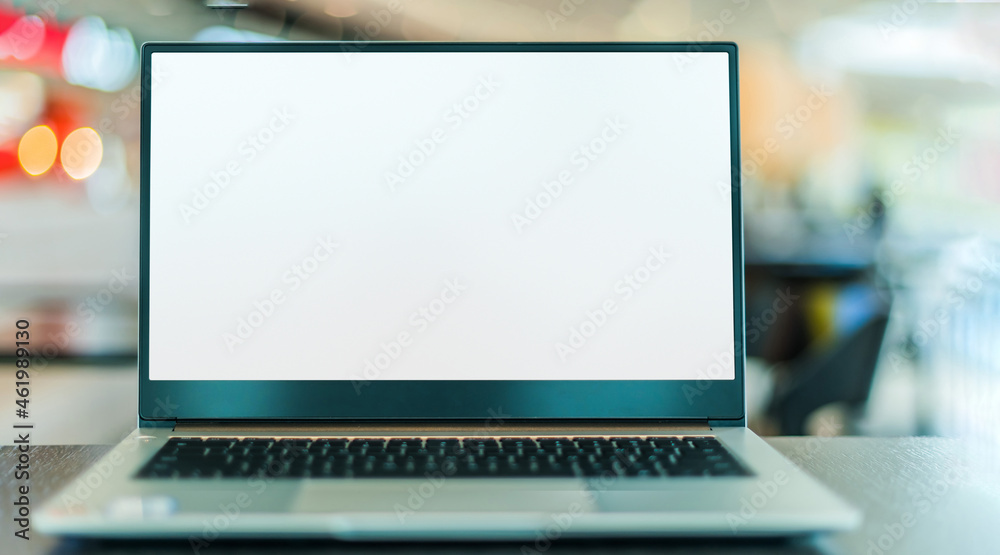 A laptop computer with an empty screen in an open space office Stock ...