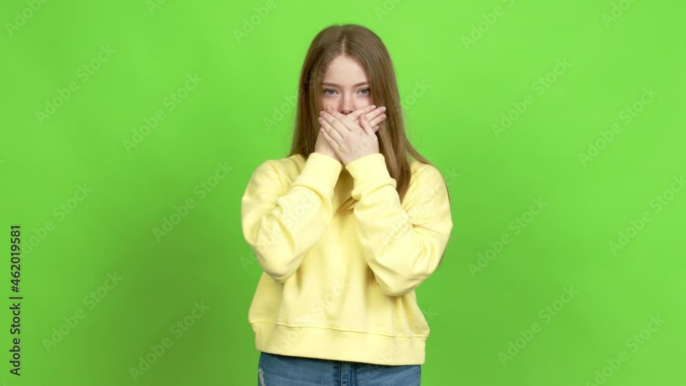 Teenager girl covering mouth with hands. Can not speak over isolated ...