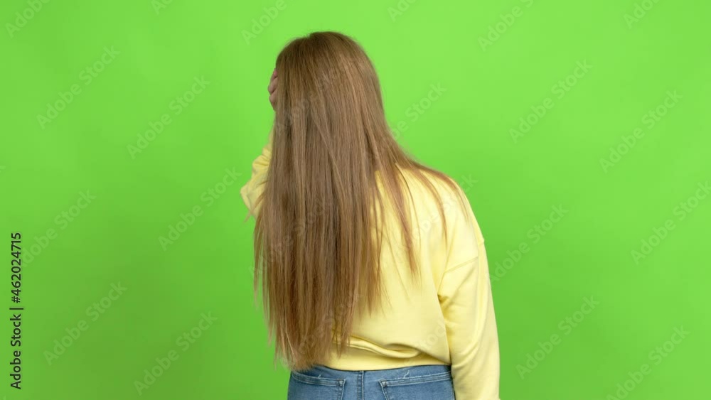 Teenager girl on back position looking back while scratching head over ...