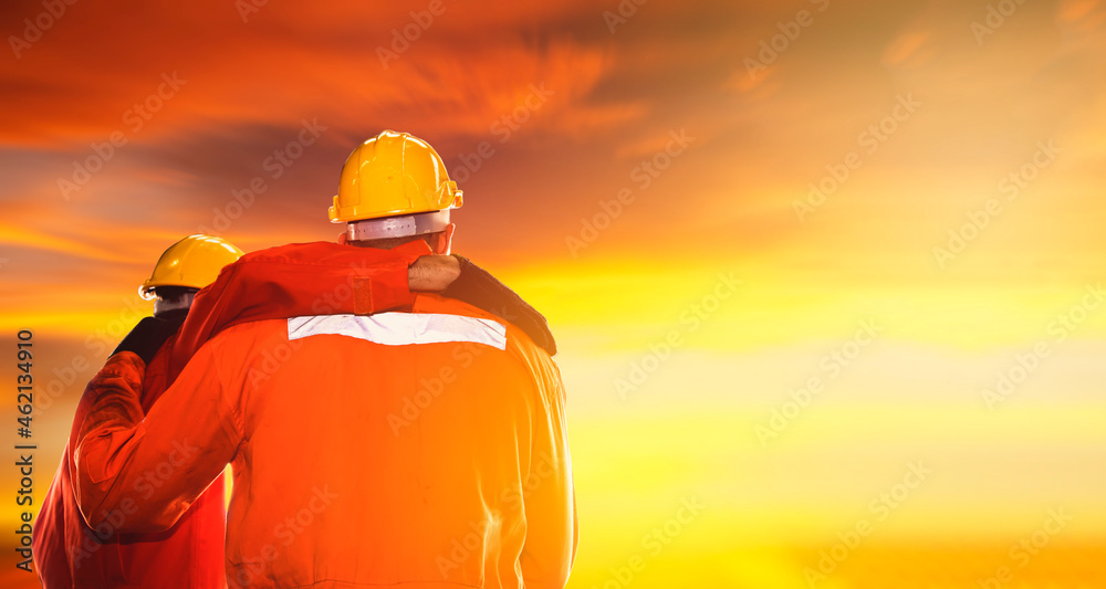 Back view engineers, machinists and factory workers working together ...