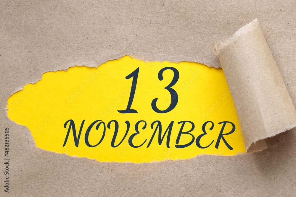 november 13. 13th day of the month, calendar date.Hole in paper with ...