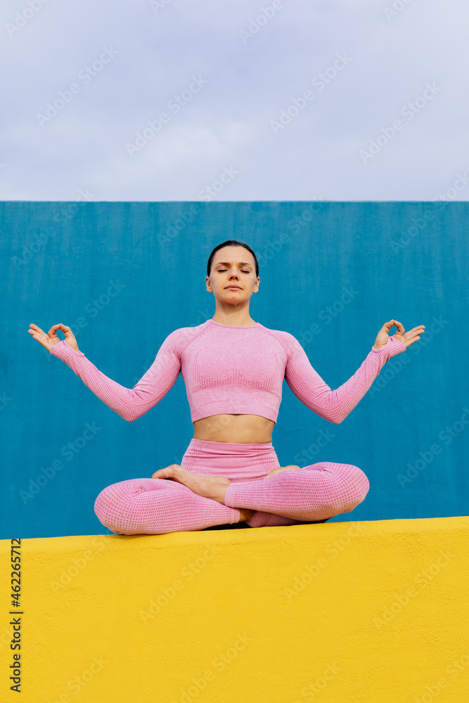 Calm woman sitting and meditating Stock Photo | Adobe Stock