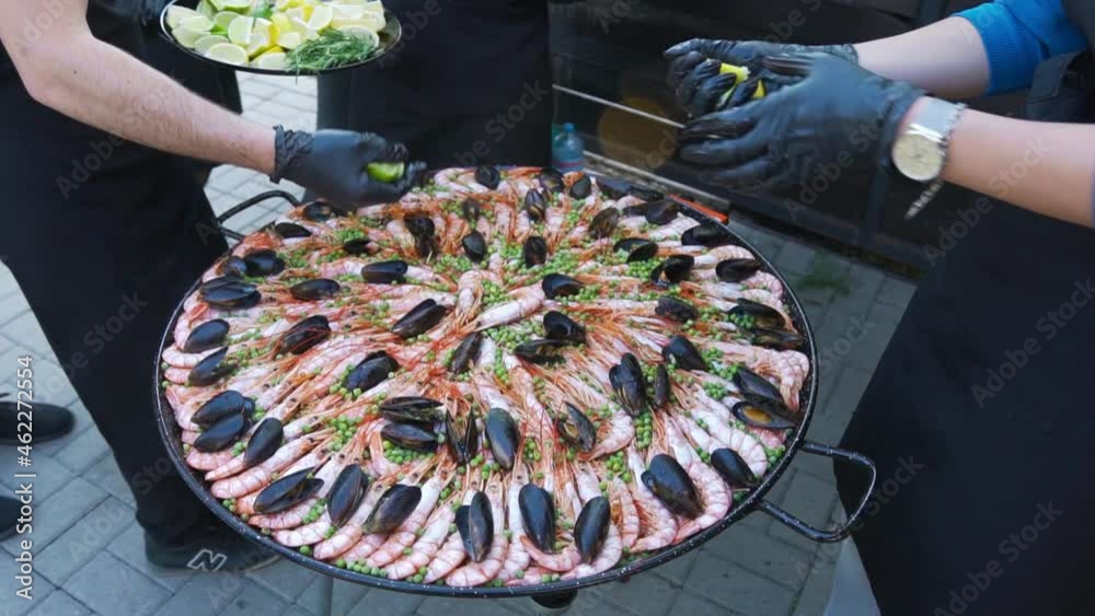 In pan chefs prepare delicious dish for gourmets of Spanish cuisine ...