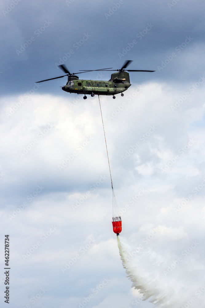 Boeing CH-47 Chinook helicopter dropping water from a water bucket ...
