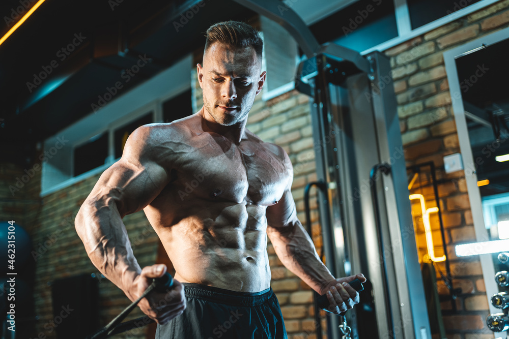 muscular bodybuilder male have workout in gym or training with sport ...