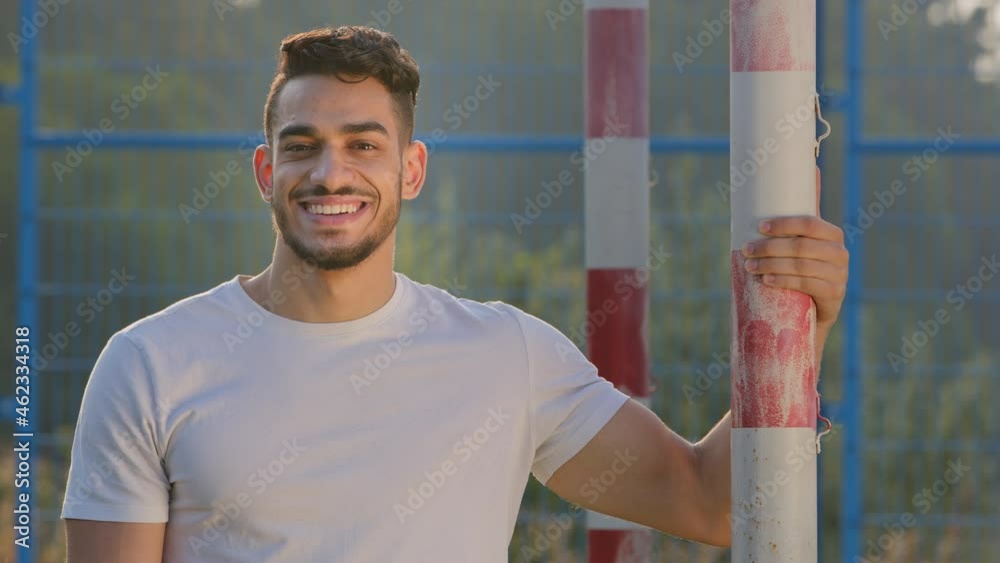 Young smiling athletic Middle Eastern Indian sportsman coach ...
