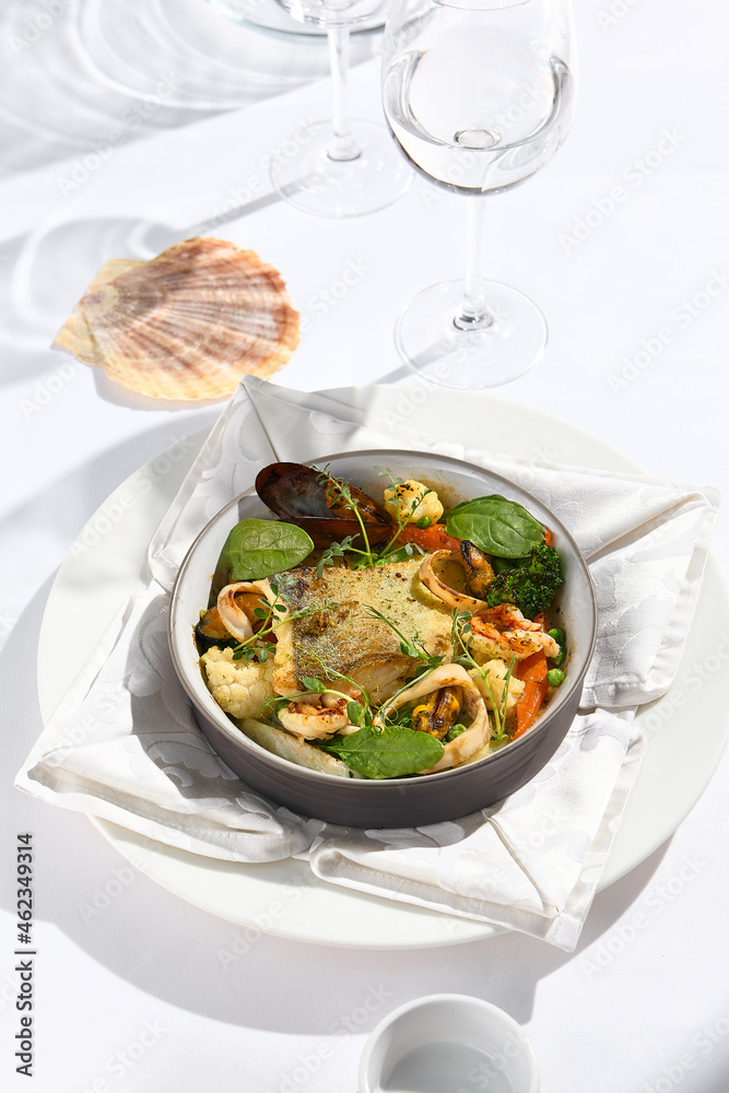 Elegant seafood stew with cod fish and vegetables in pot. Healthy fish ...