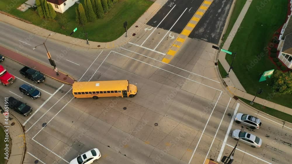 Yellow school bus with students inside making a left turn at an ...