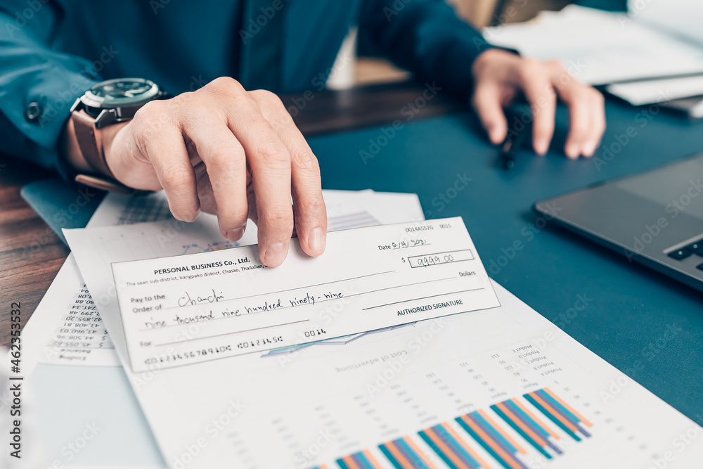 A Businessperson's hand giving cheque to customer and dollar bill, coin ...