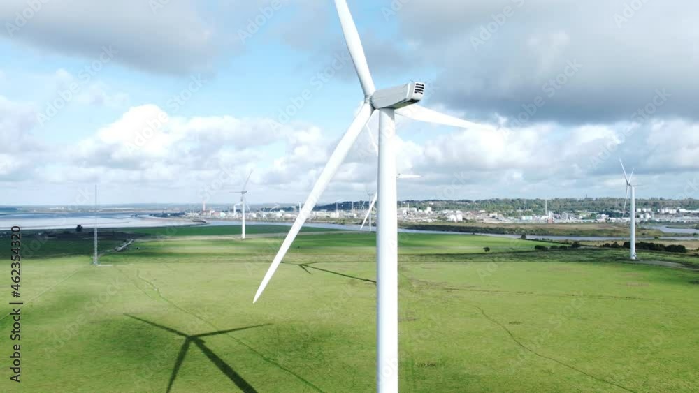 Aerial view flying around renewable energy wind farm wind turbines ...