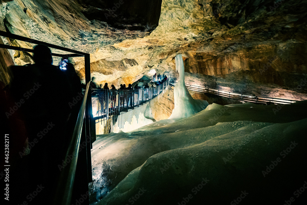 Tourists crossing a rope bridge at the Tristandom inside the Dachstein ...