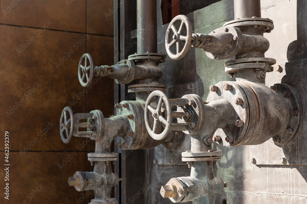 Old rusty valves of industrial oven from steam revolution times with ...