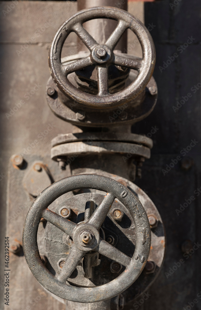 Old rusty valves of industrial oven from steam revolution times with ...