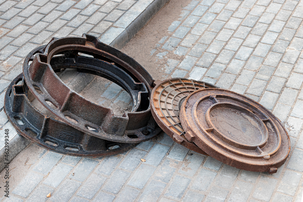 New cast iron manholes prepared for installation at the construction ...
