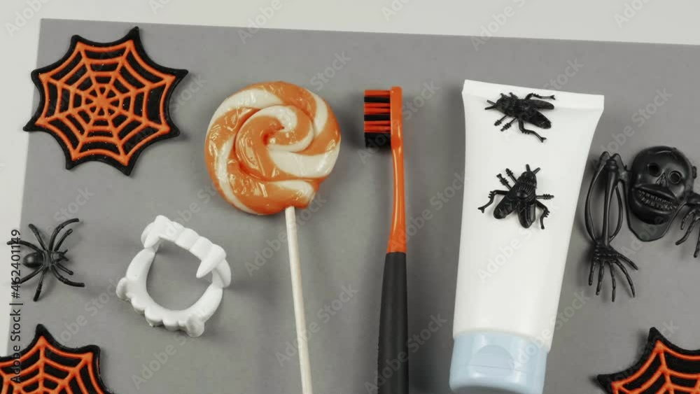 Layout top view of toothpaste, brush, vampire teeth and spider webs in ...