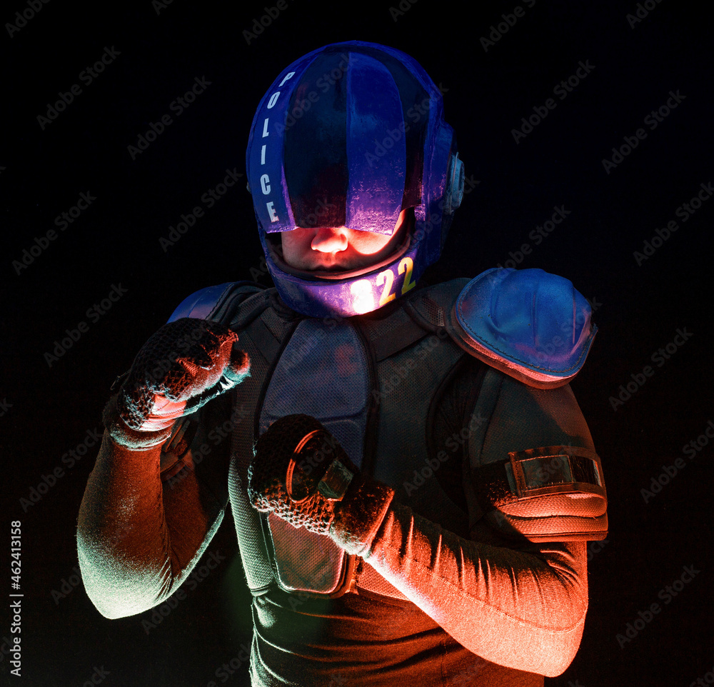Cyberpunk future concept. Police officer stands in boxing pose and ...
