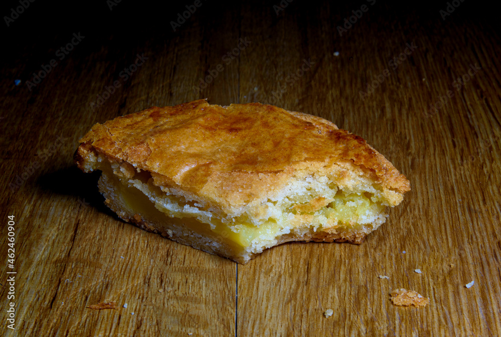 one half bitten, with a bite, frenete, sponge cake and pastry cream ...